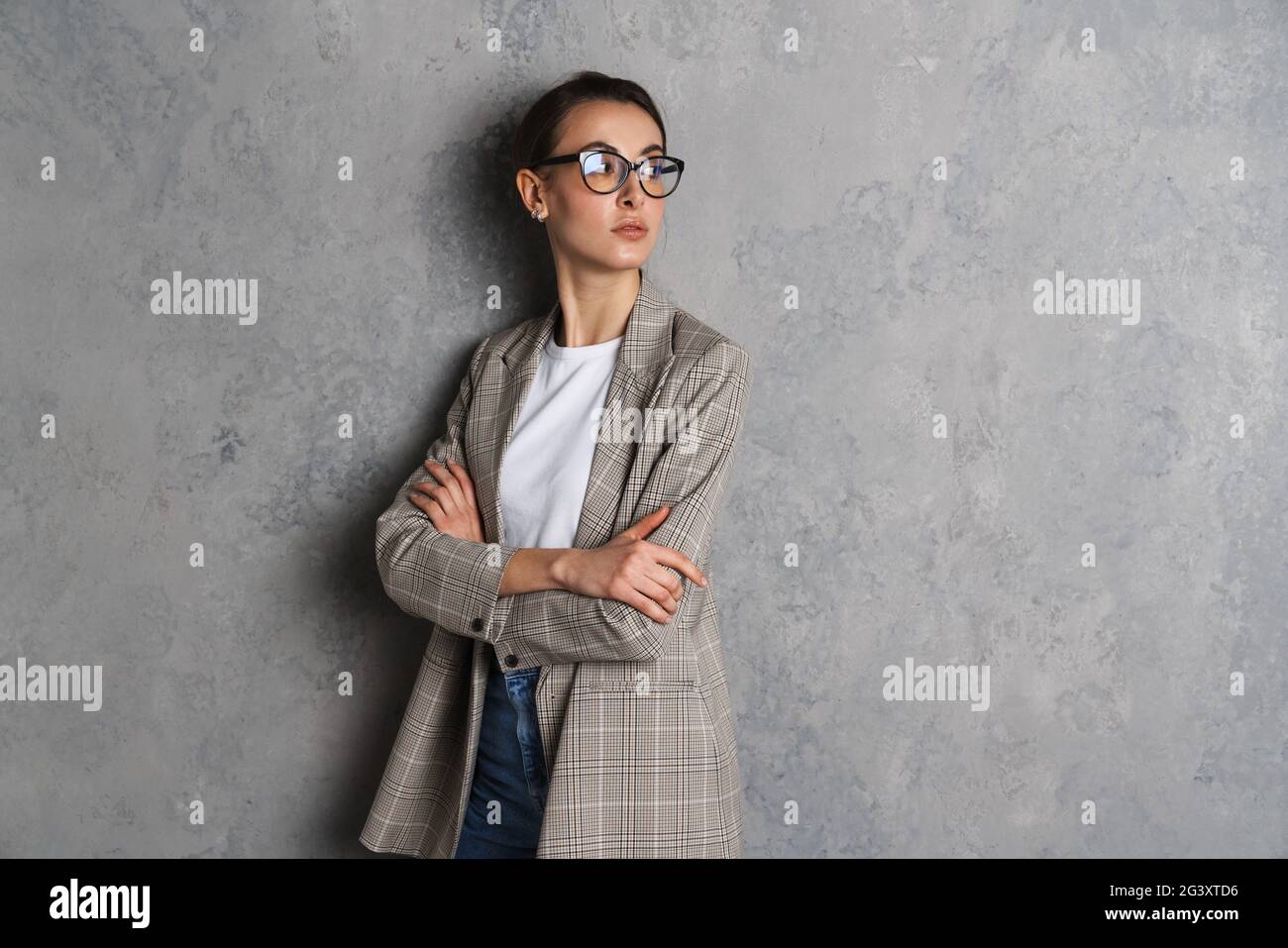 Confident attractive young casual woman wearing casual jacket standing ...