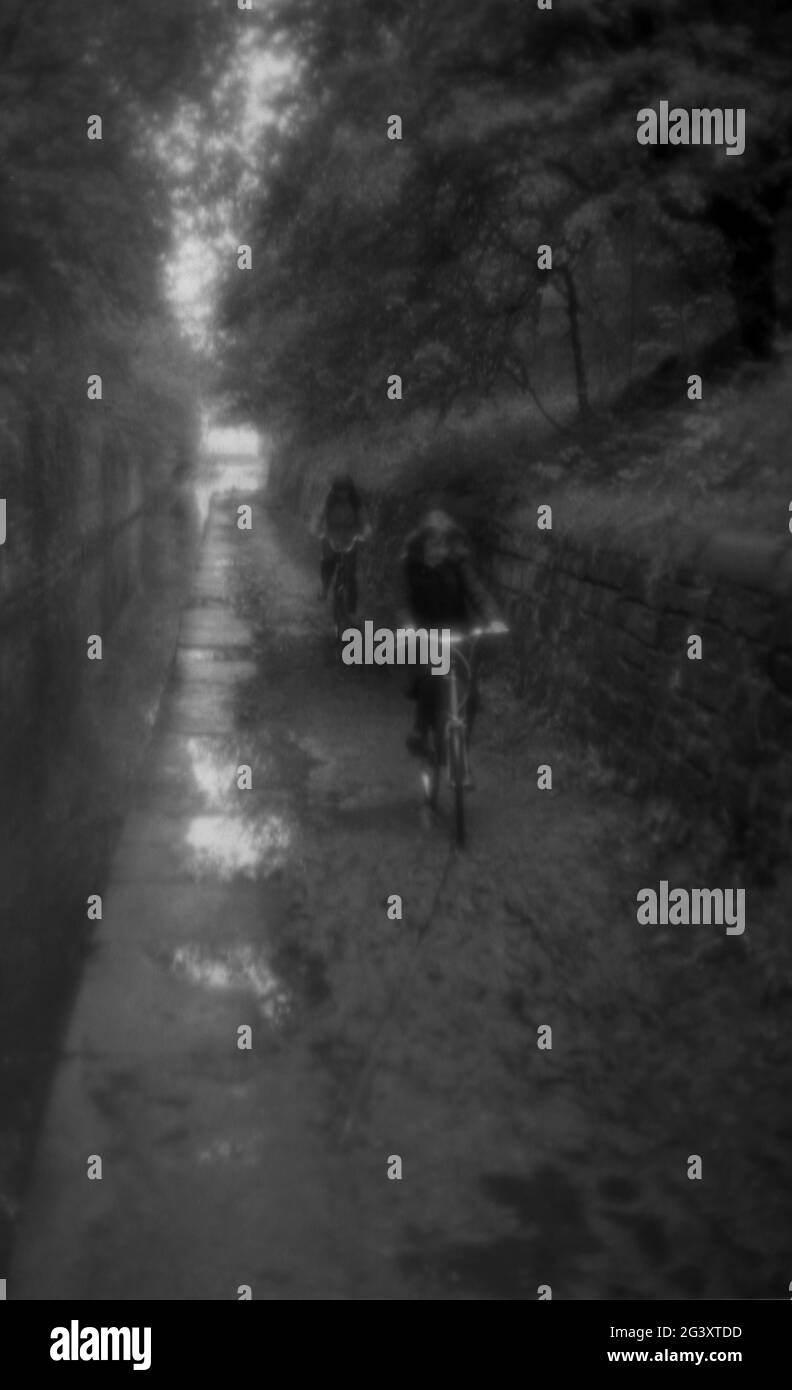 Two girls cycling on towpath of the Macclesfield Canal Stock Photo - Alamy