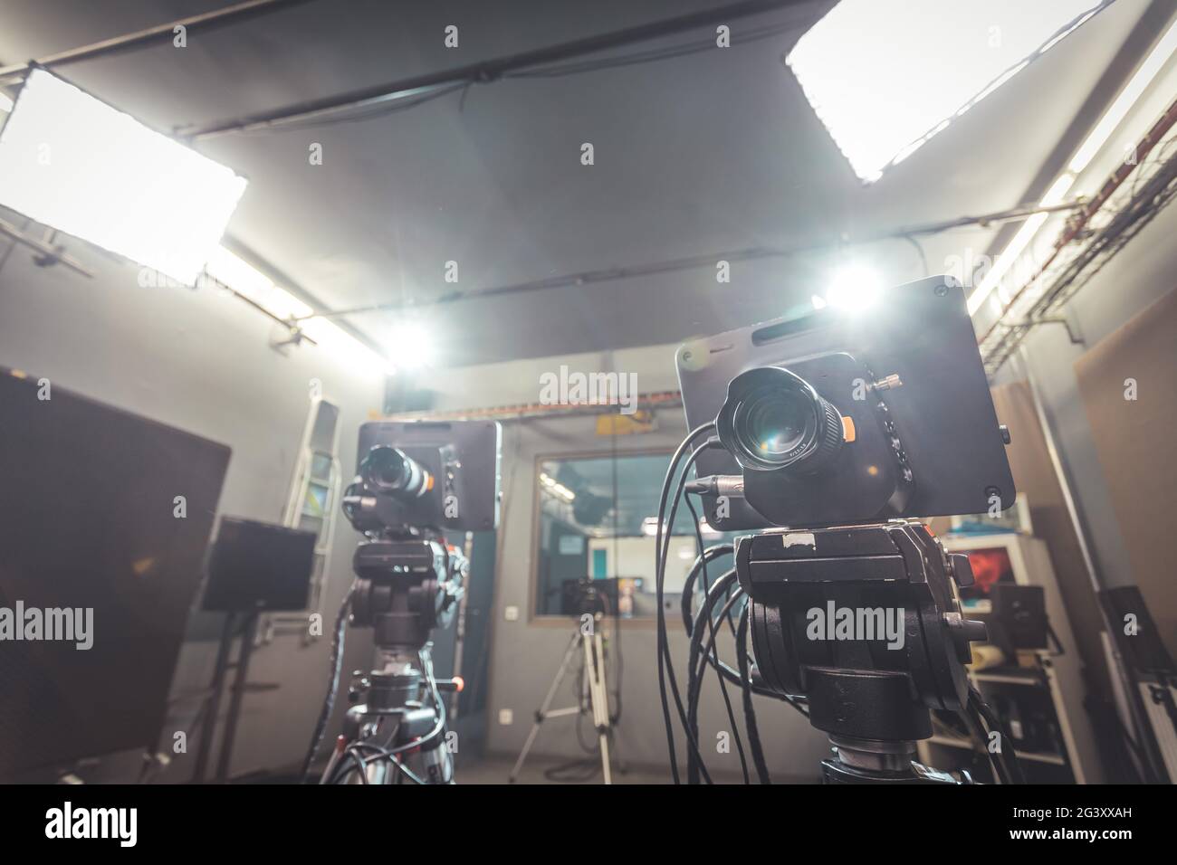 Young journalist in a television recording studio is talking into a ...