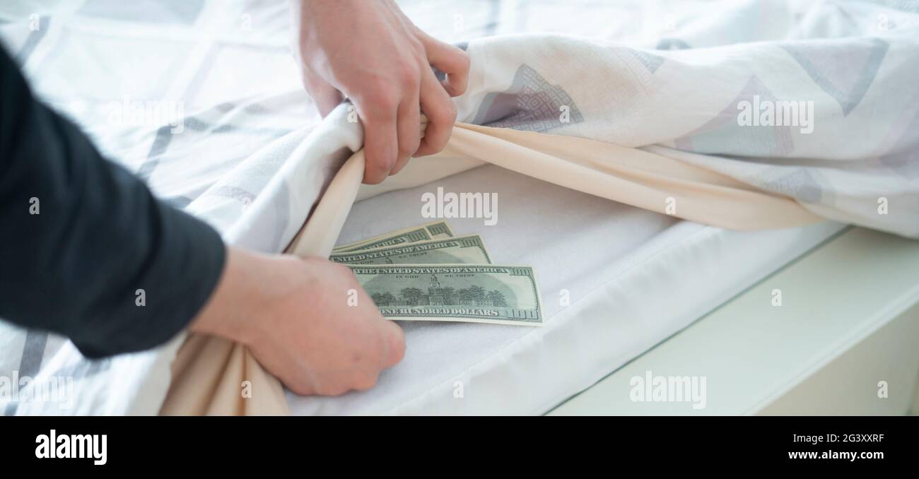 taking hidden stash of cash money from the wardrobe at home Stock Photo ...
