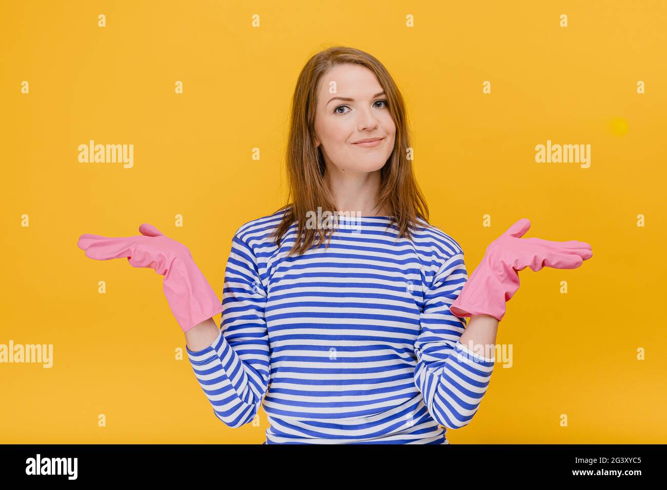 Pretty female model shows something on blank space open palm in rubber ...