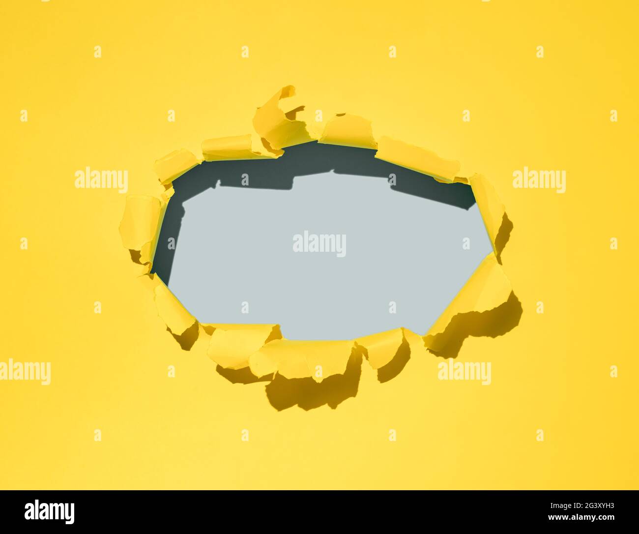 Torn yellow background, empty hole in center Stock Photo - Alamy