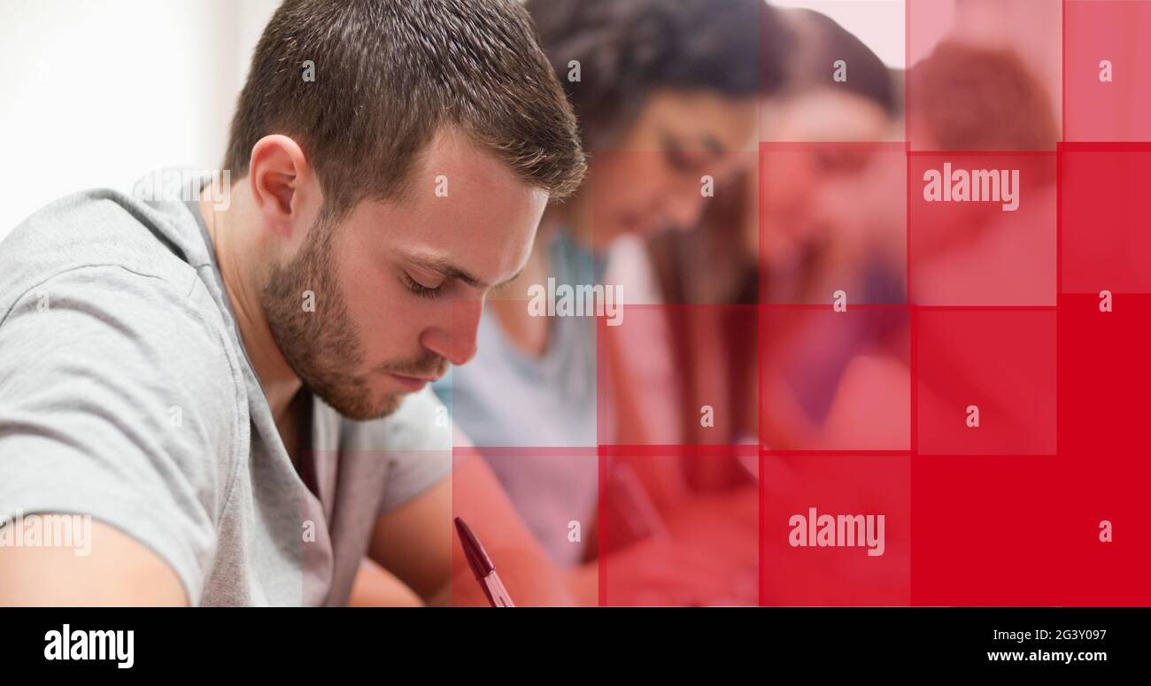 Composition of students concentrating, writing in class, with red block ...