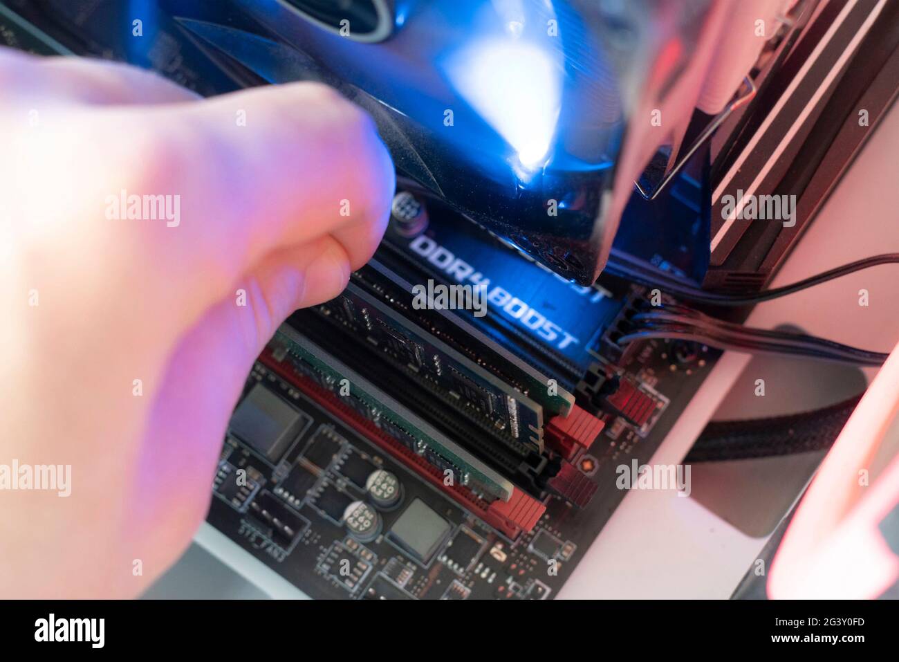 inserting plug in the ram ddr memory card in the computer mainboard ...