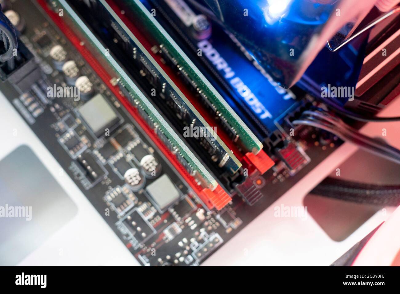 inserting plug in the ram ddr memory card in the computer mainboard ...