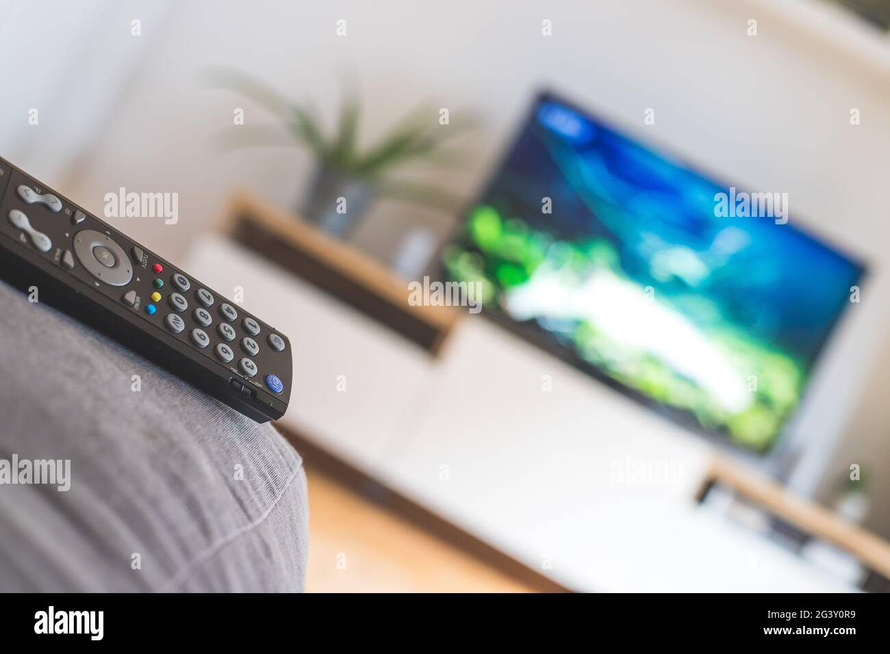 Remote control on the sofa, streaming on a smart TV Stock Photo - Alamy