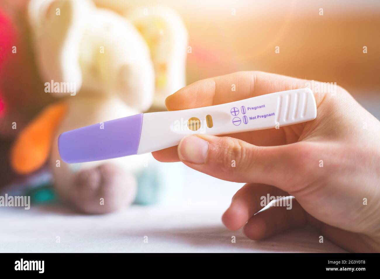 Woman checking pregnancy test. Result positive Stock Photo - Alamy