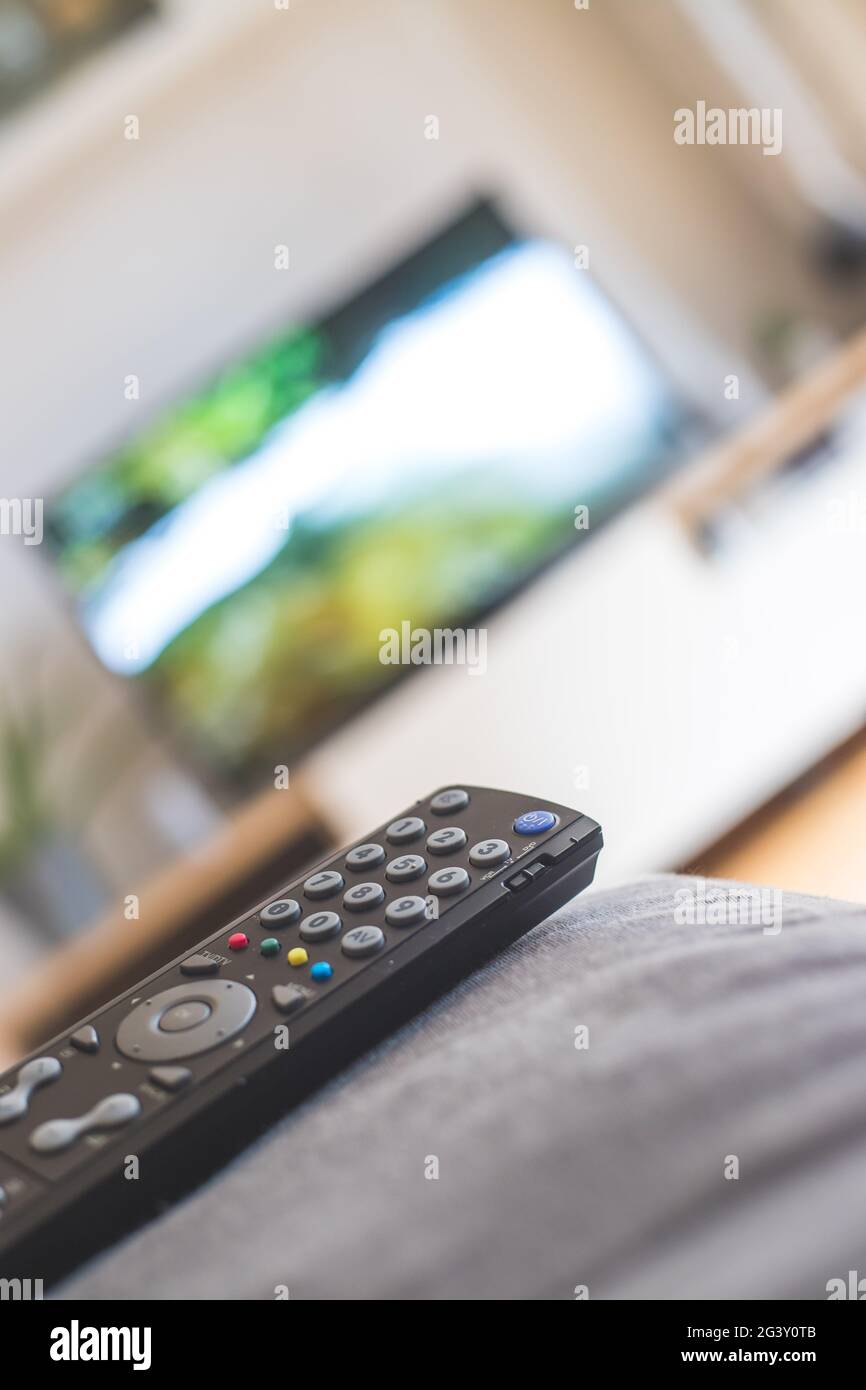 Remote control on the sofa, streaming on a smart TV Stock Photo - Alamy