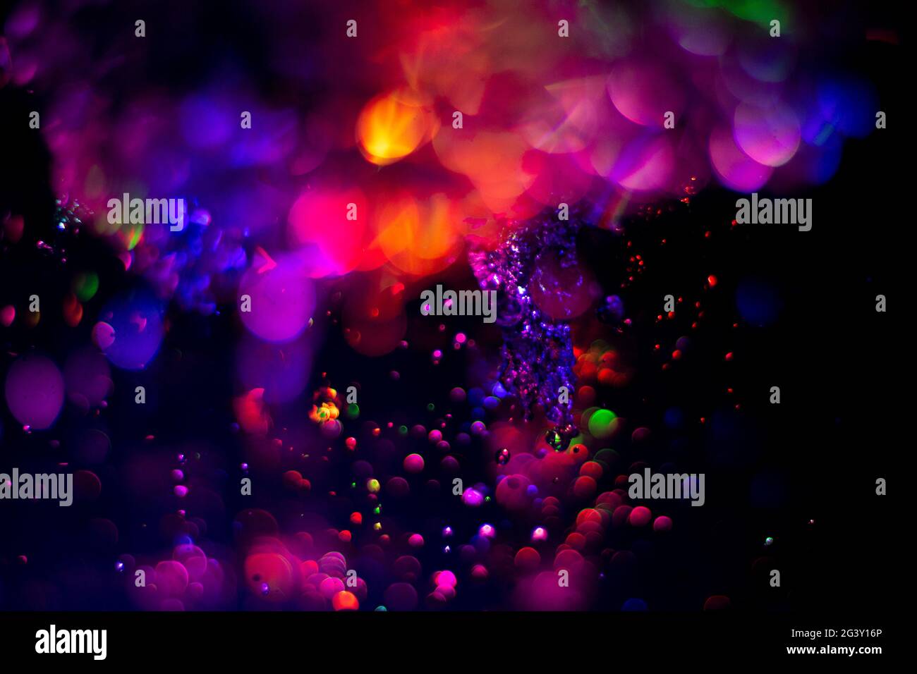 Colored water texture. Splashes of water lit in different colors. Close ...