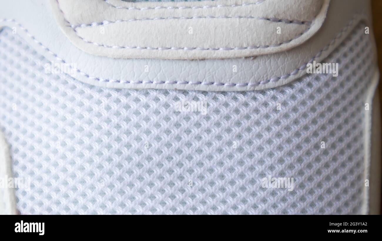 White color mesh fabric on a part of sports shoes. Running shoe net ...