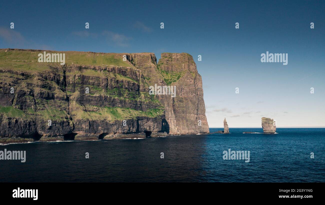 Risin og Kellingin rocks on Faroe Islands during the day with sun and ...