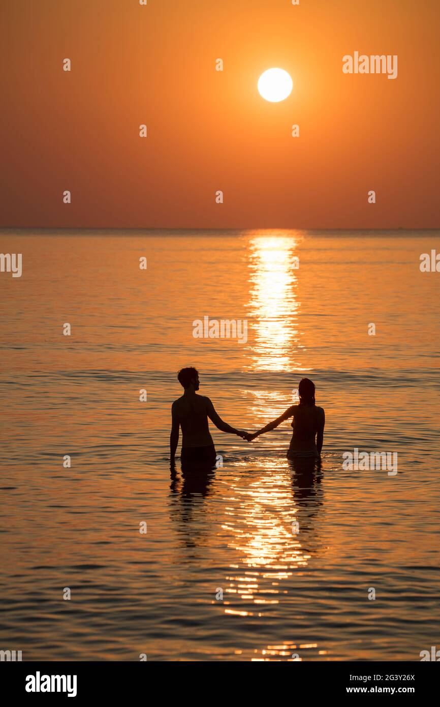 Couple sunbathing beach silhouette hi-res stock photography and images ...