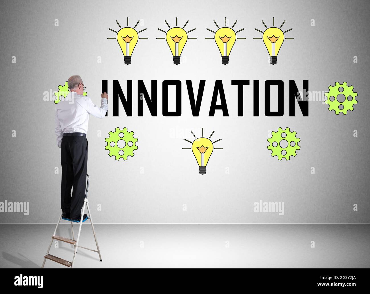 Man on a ladder drawing innovation concept on a wall Stock Photo - Alamy