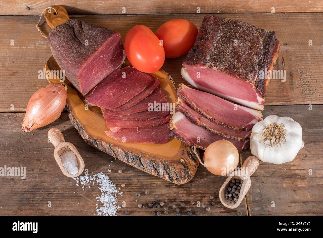 Smoked meats on wooden background Stock Photo - Alamy