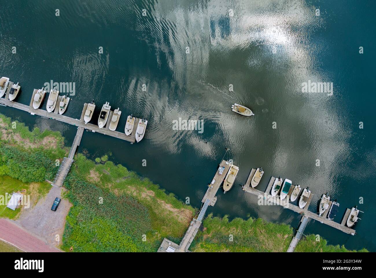 Aerial view of speedboat floating near pier little wood platform dock ...