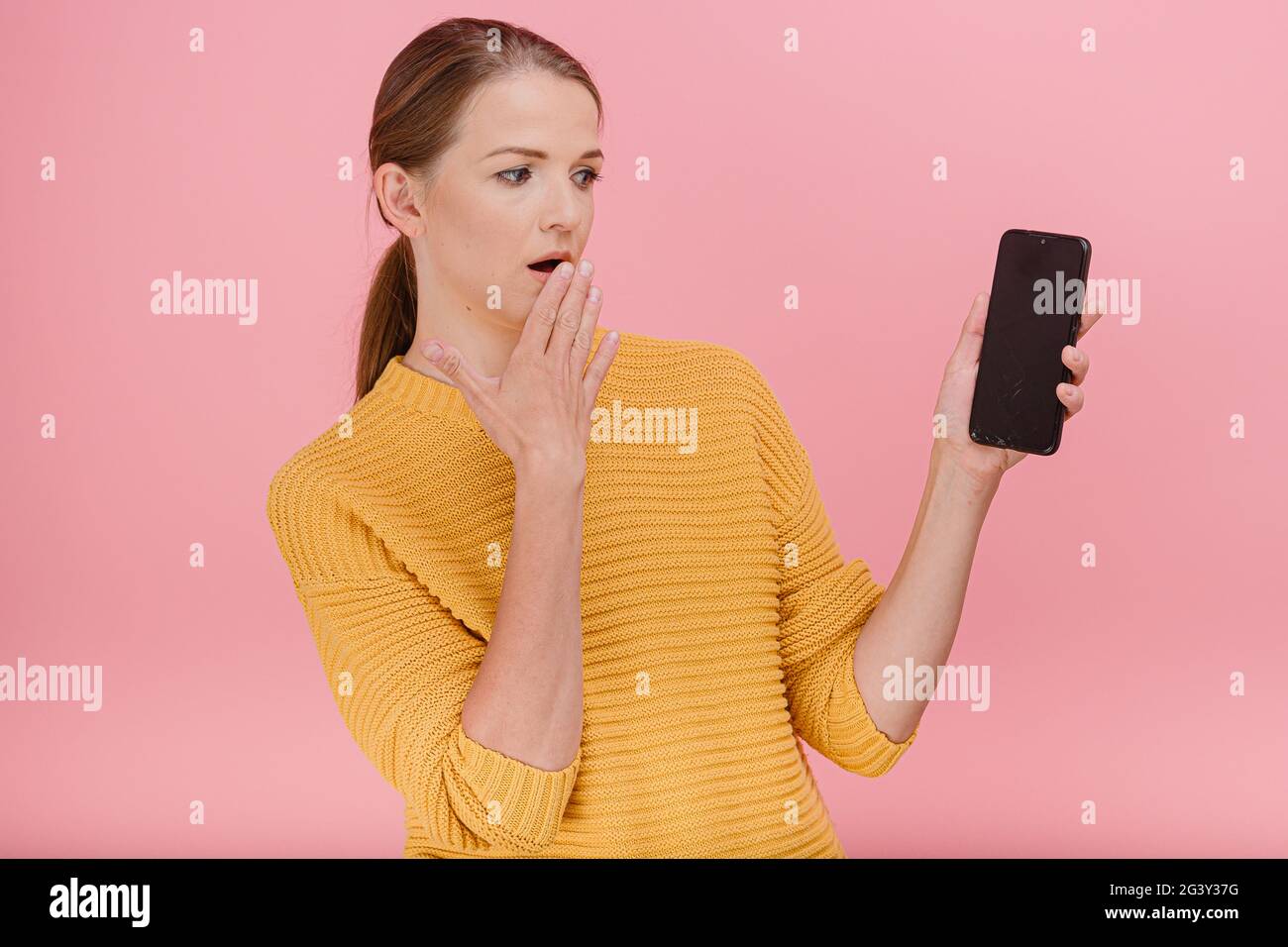 Horizontal portrait female model hold broken phone with scratches in ...