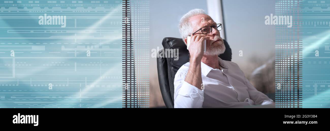 Portrait of bearded senior businessman talking on mobile phone in ...