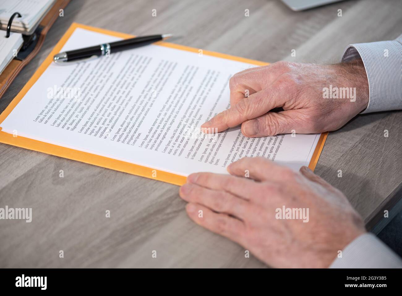 Businessman checking a document in office Stock Photo - Alamy