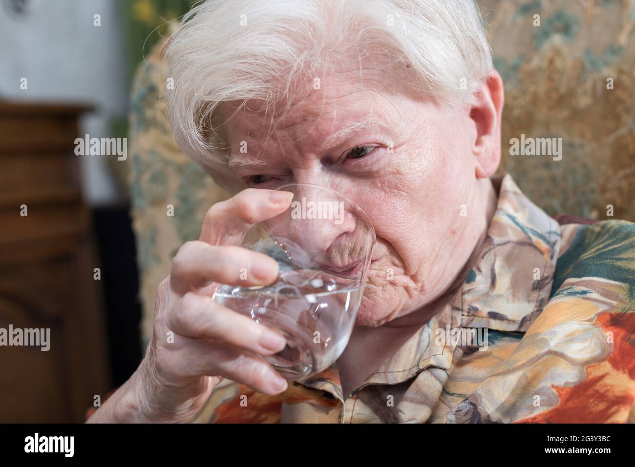 Senior drinking water at home Stock Photo - Alamy