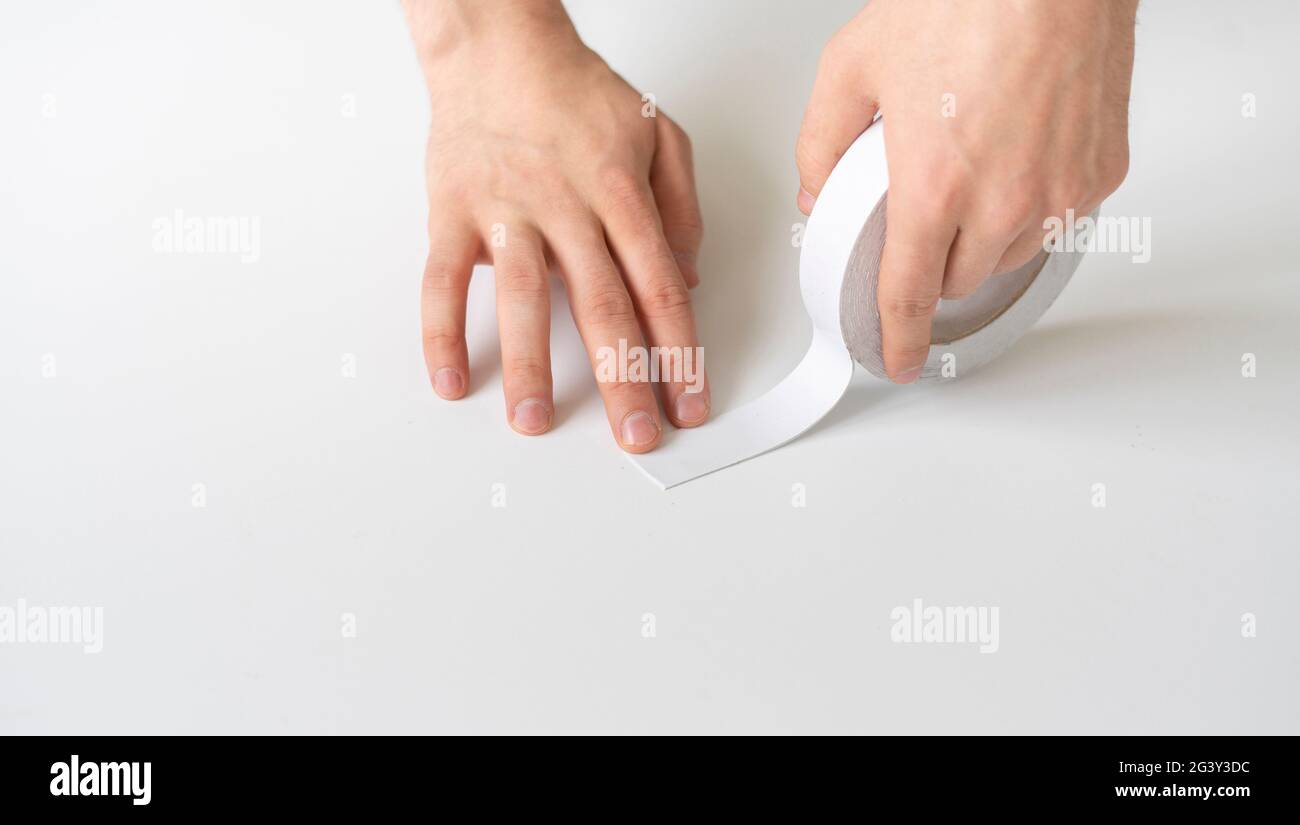 hands holding and a[[lying adhesive tape on the surface Stock Photo - Alamy