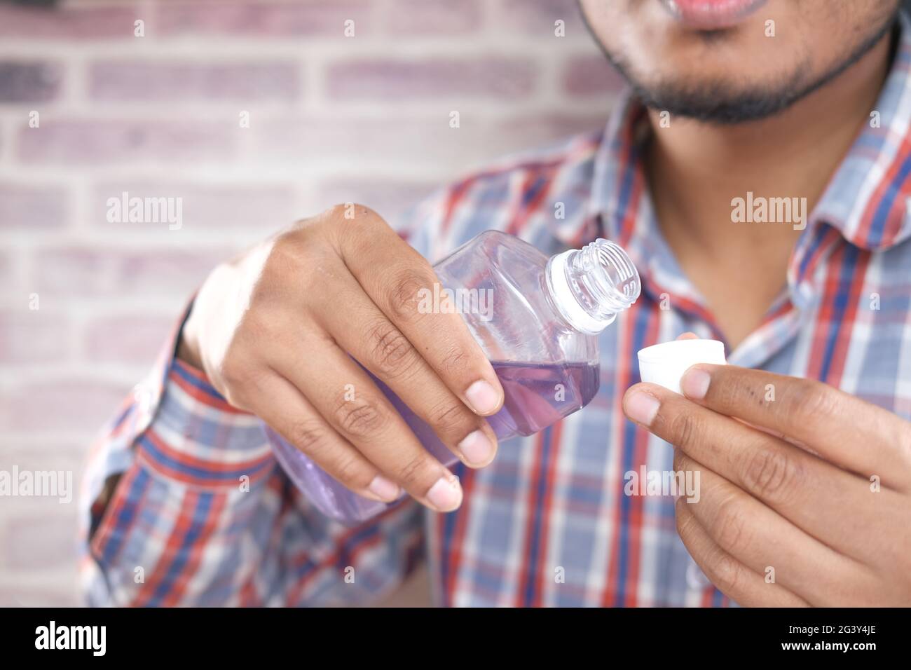mouthwash liquid flowing into a cap Stock Photo - Alamy