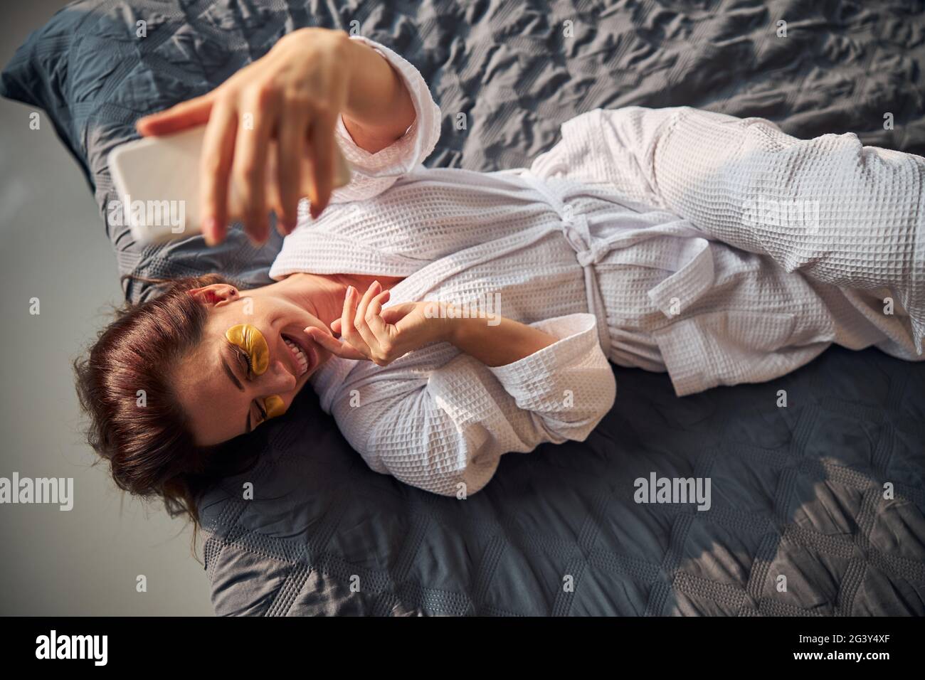 Shy female person keeping smile on her face Stock Photo - Alamy