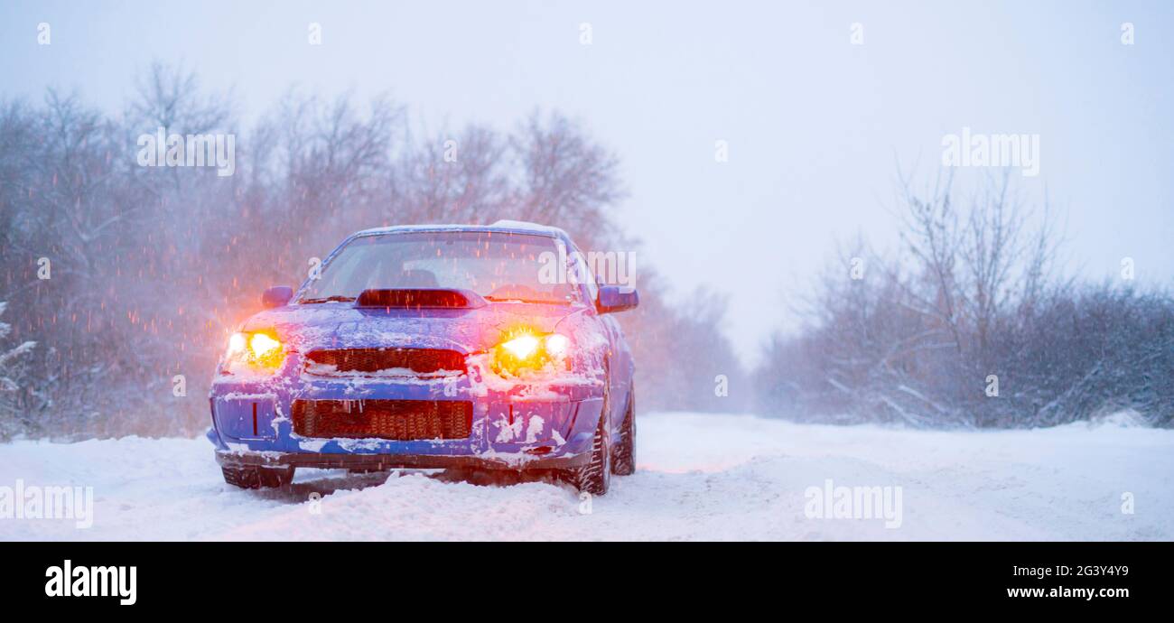 fast blue sport car on winter snowy day, cold season, street road Stock ...