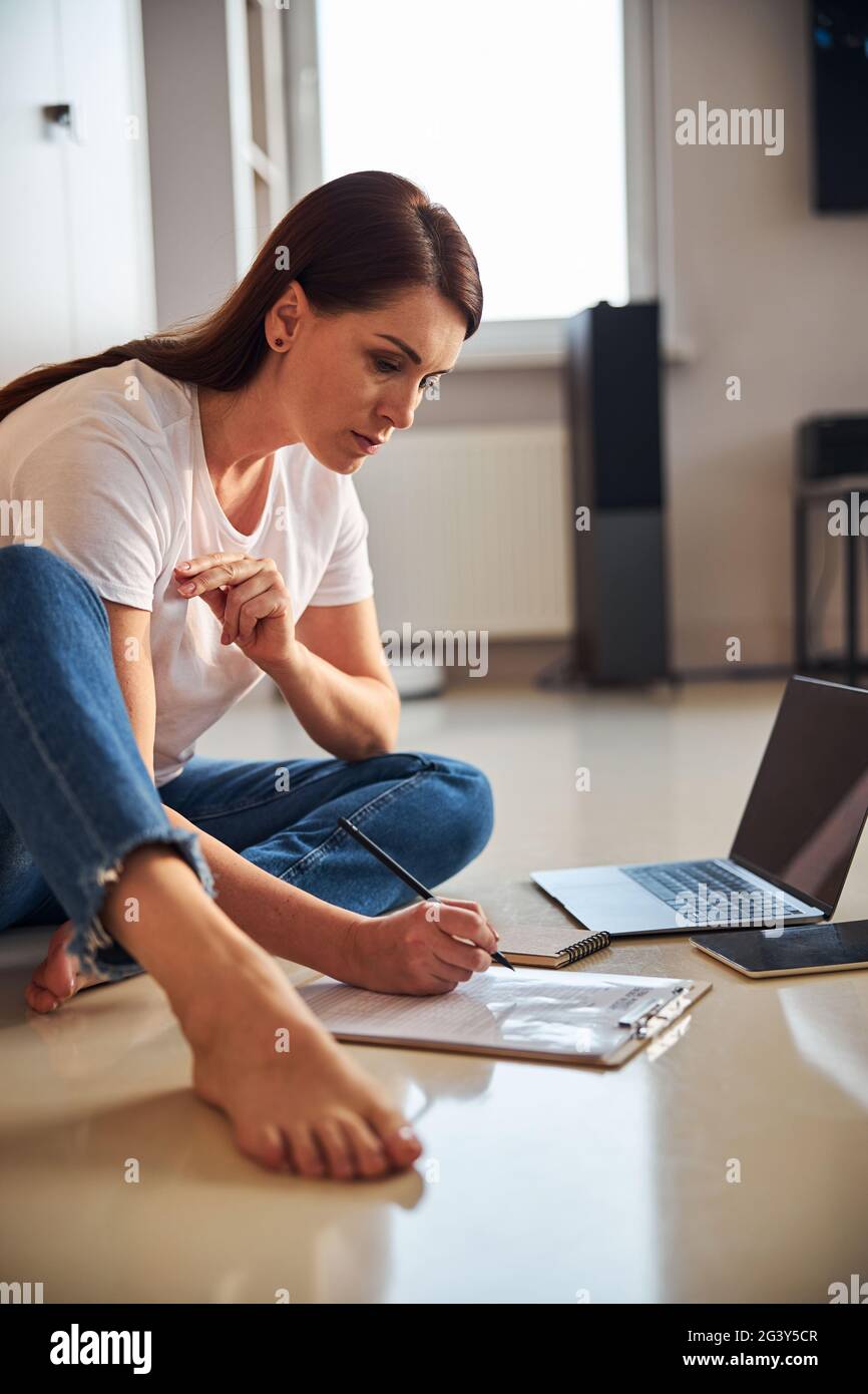 Attentive woman making notes hi-res stock photography and images - Alamy