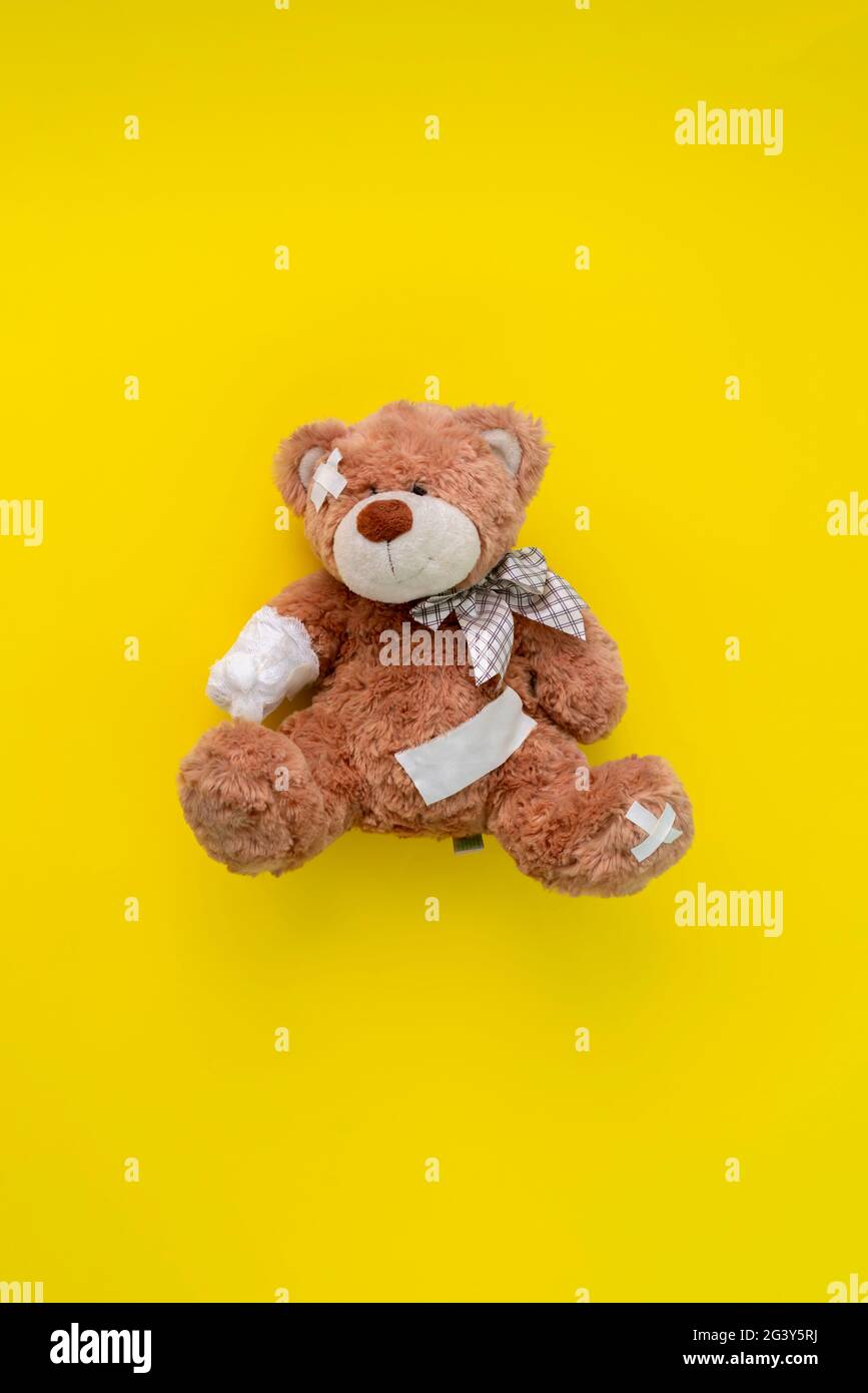 concept of pain and illness problem, teddy bear toy wrapped in bandage ...