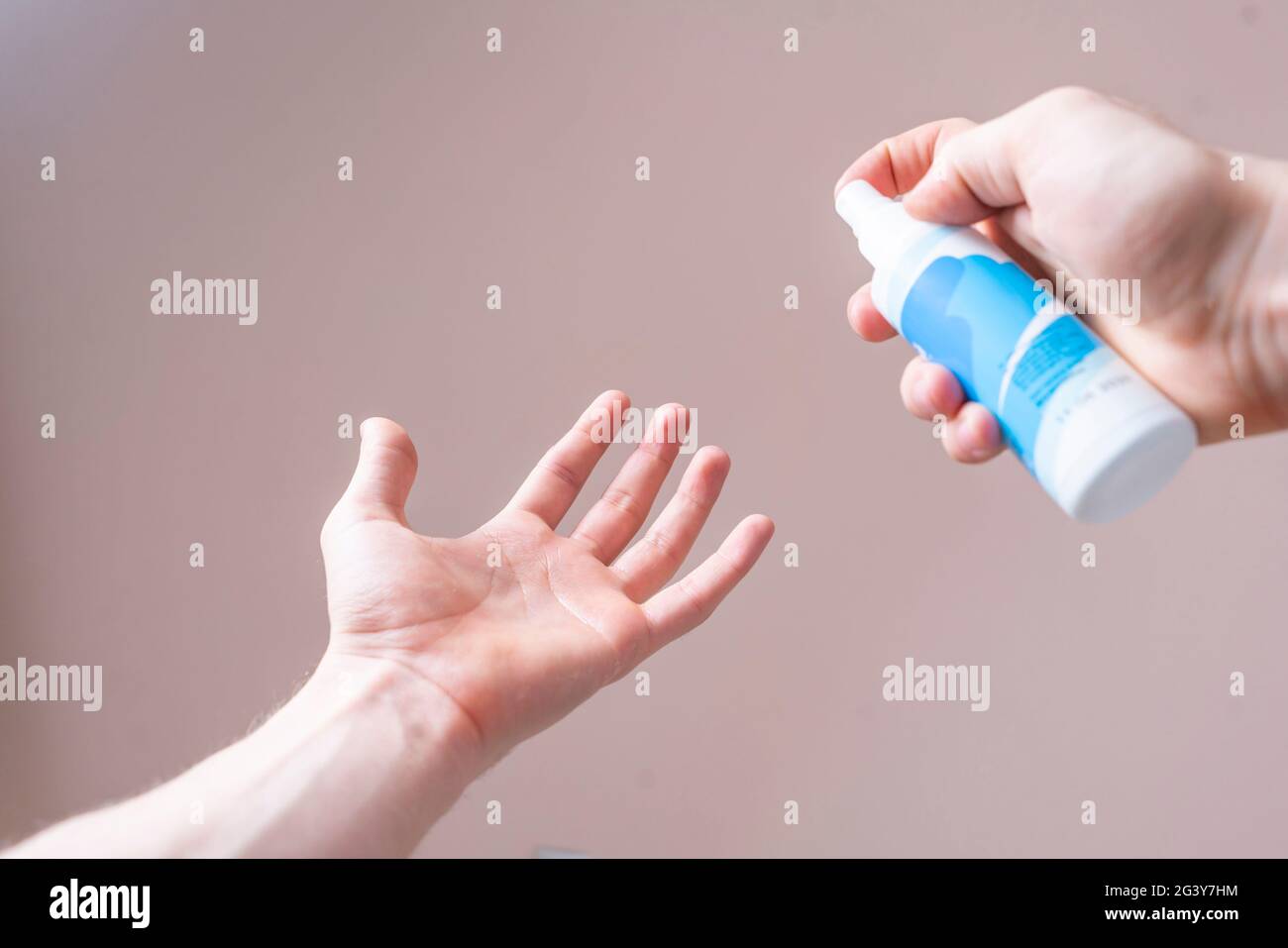 using a spray antibacterial bottle to wash hands, healthcare sanitizer ...