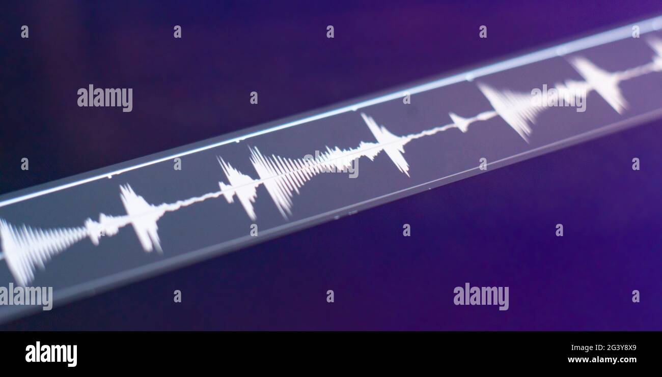 macro view of the computer monitor screen with sound audio wave graph ...