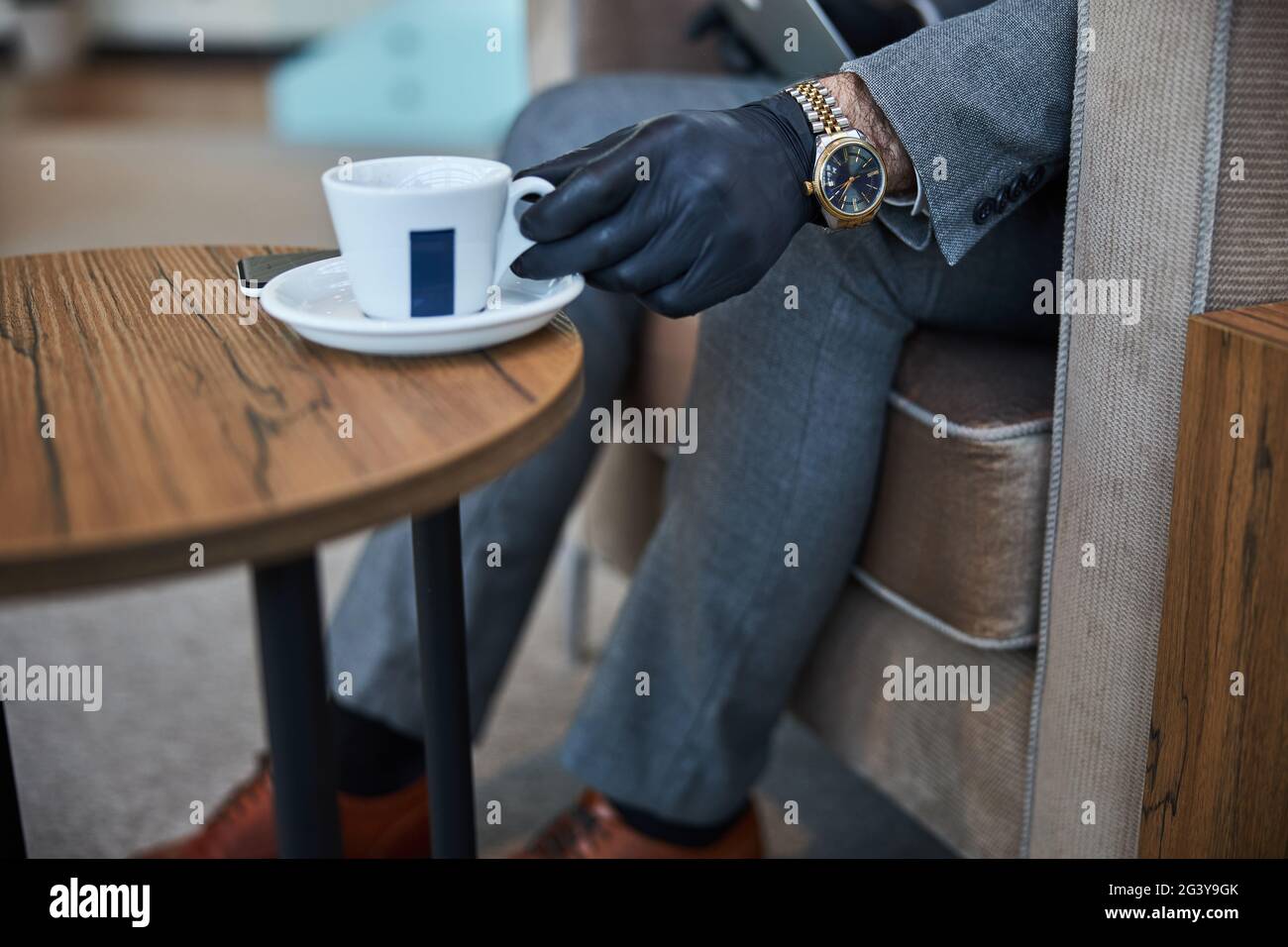 Putting cup on the plate while drinking coffee Stock Photo - Alamy