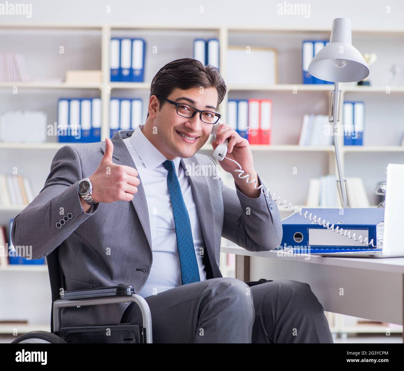 Disabled businessman working in the office Stock Photo - Alamy