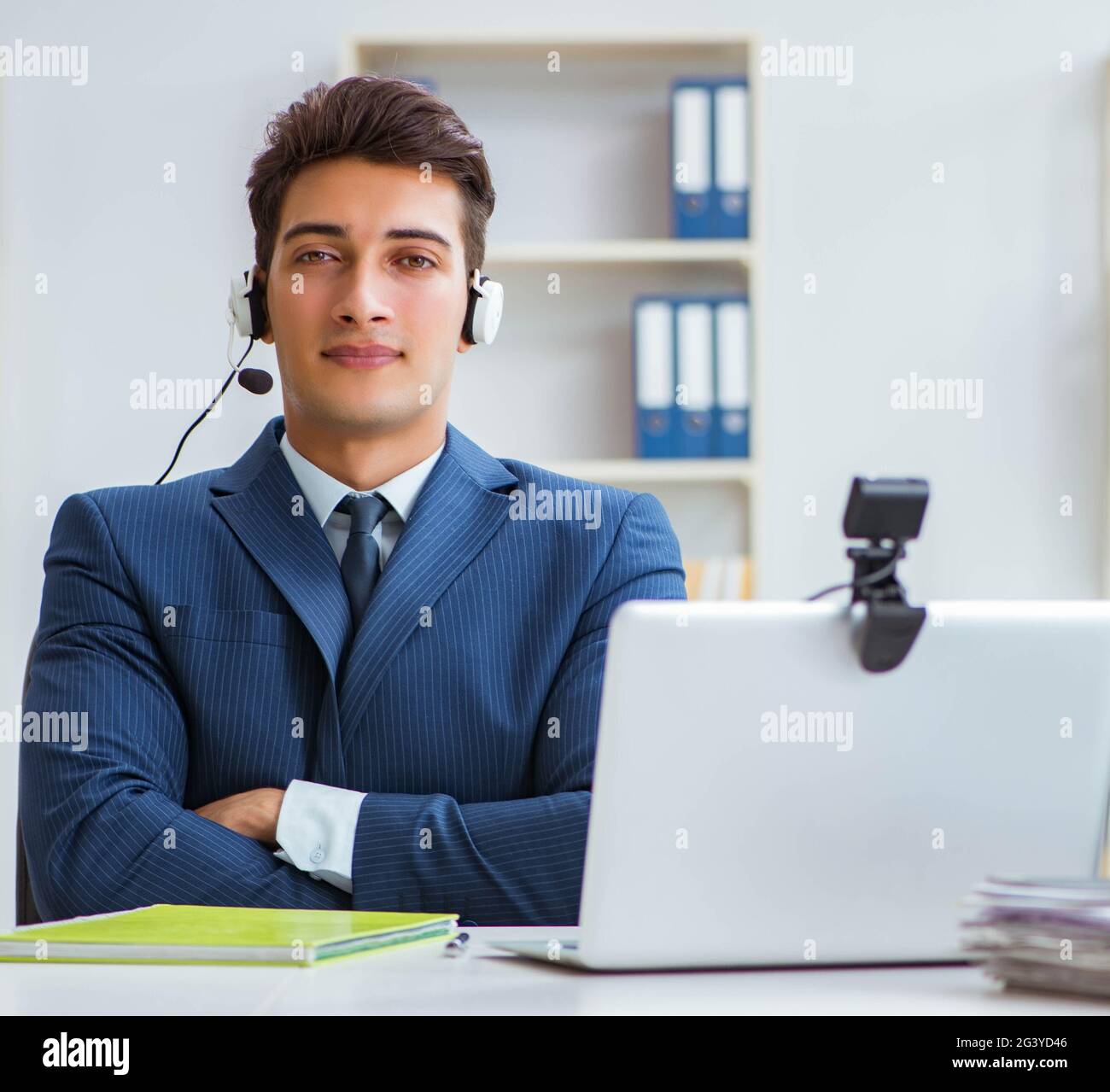 Young help desk operator working in office Stock Photo - Alamy