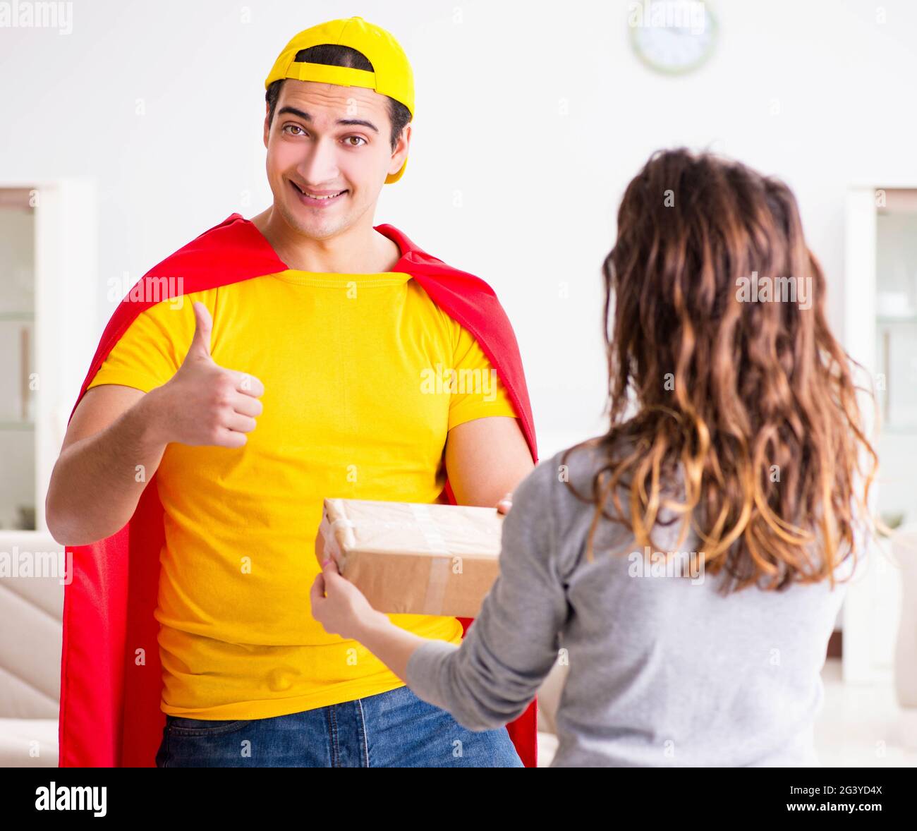 Superhero delivery guy with box Stock Photo - Alamy