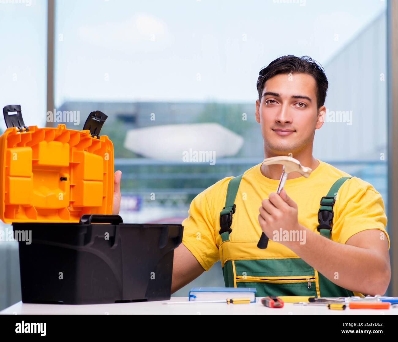 Construction worker sitting at the desk Stock Photo - Alamy