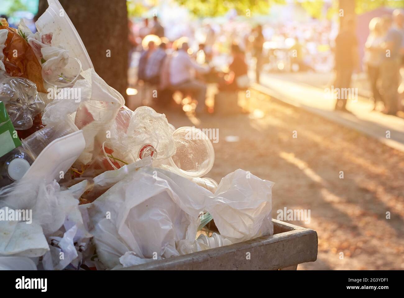 Waste container filled with plastic bottles, dishes and other rubbish ...