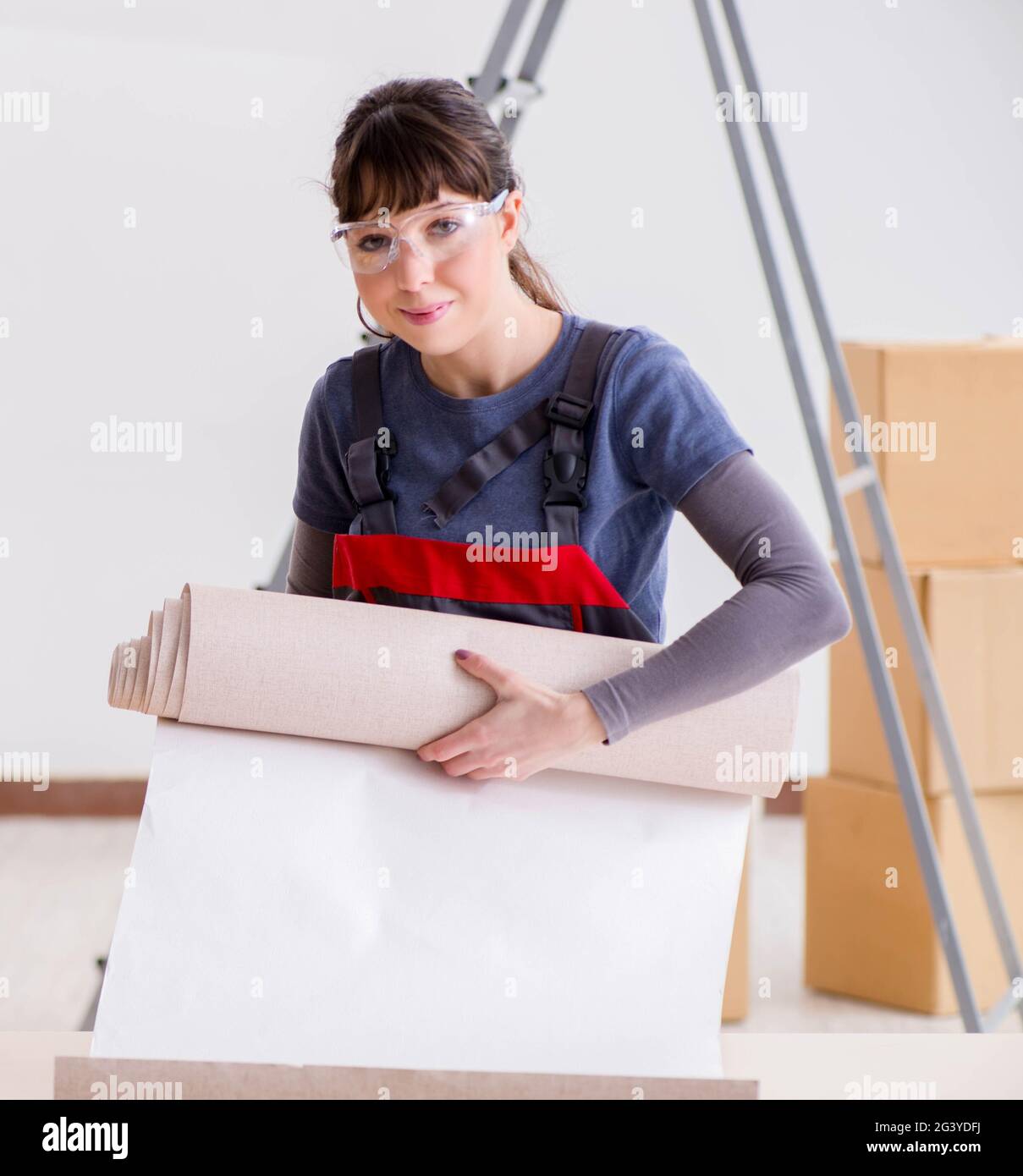 Woman preparing for wallpaper work Stock Photo - Alamy