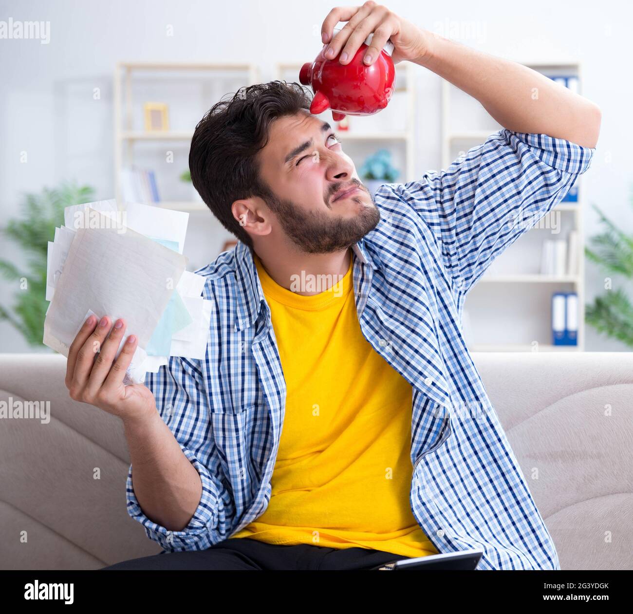 Man angry at bills he needs to pay Stock Photo - Alamy