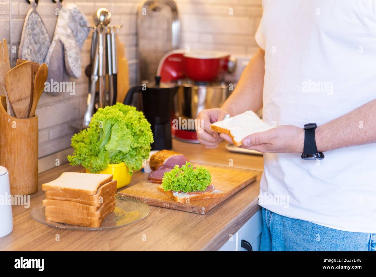 man making sandwich on the kitchen copy space Stock Photo - Alamy