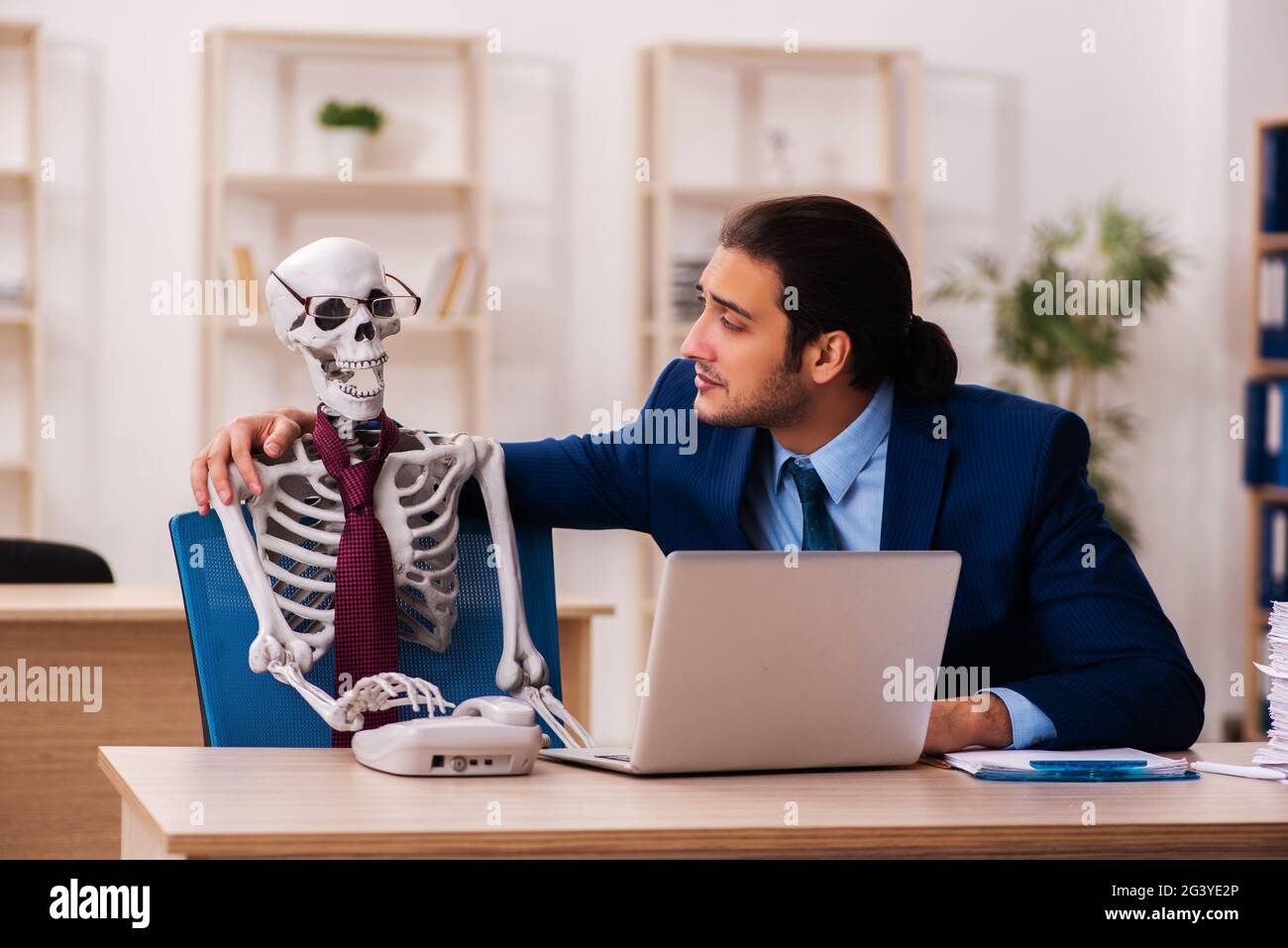 Dead employee working in the office Stock Photo - Alamy