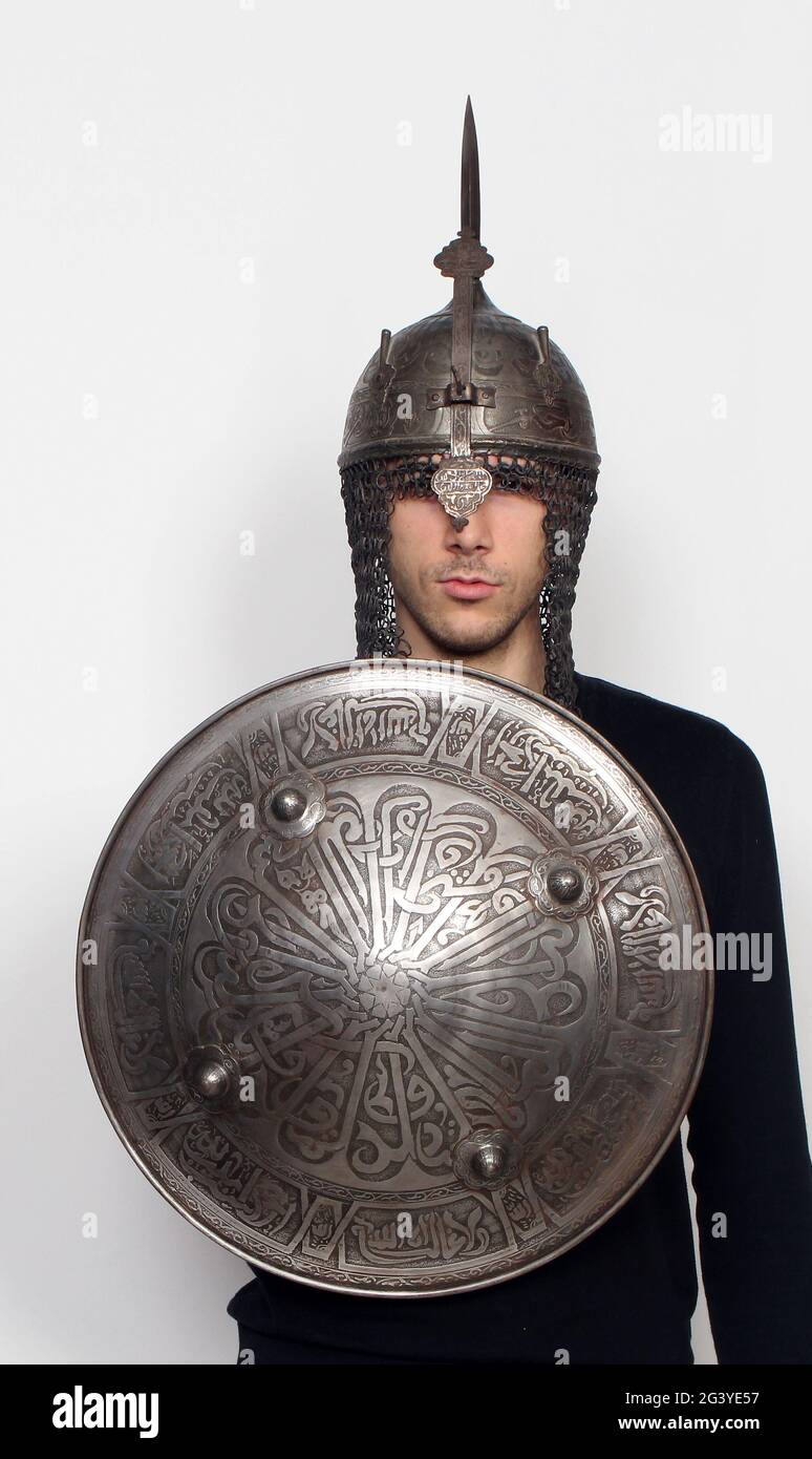 Urban warrior is posing in studio on isolated background. Costumes ...