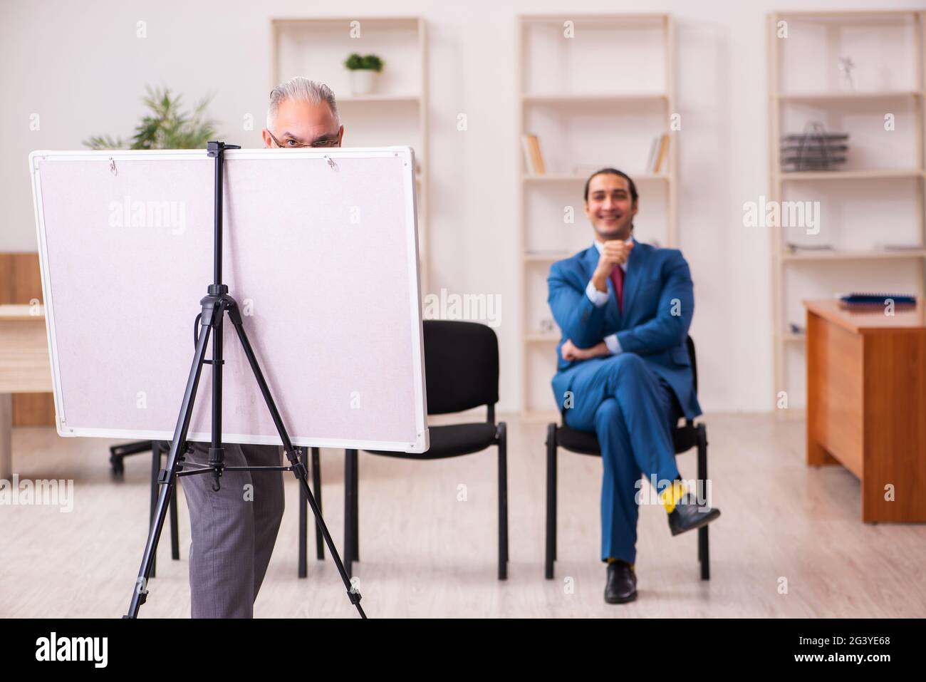 Two male employees in business meeting concept Stock Photo - Alamy
