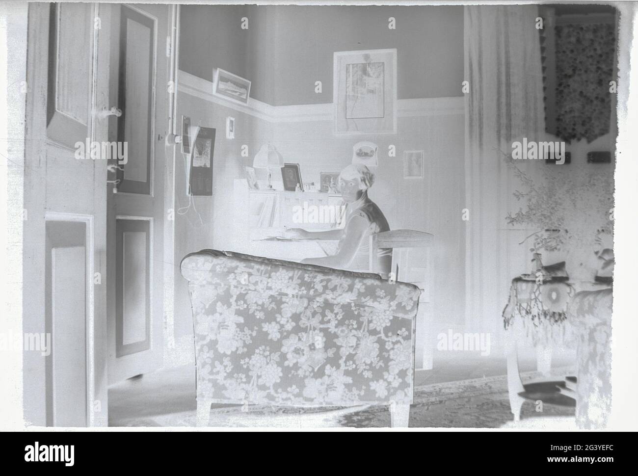 Woman referred to as suzi sitting on a couch in a room. Part of Kodak ...