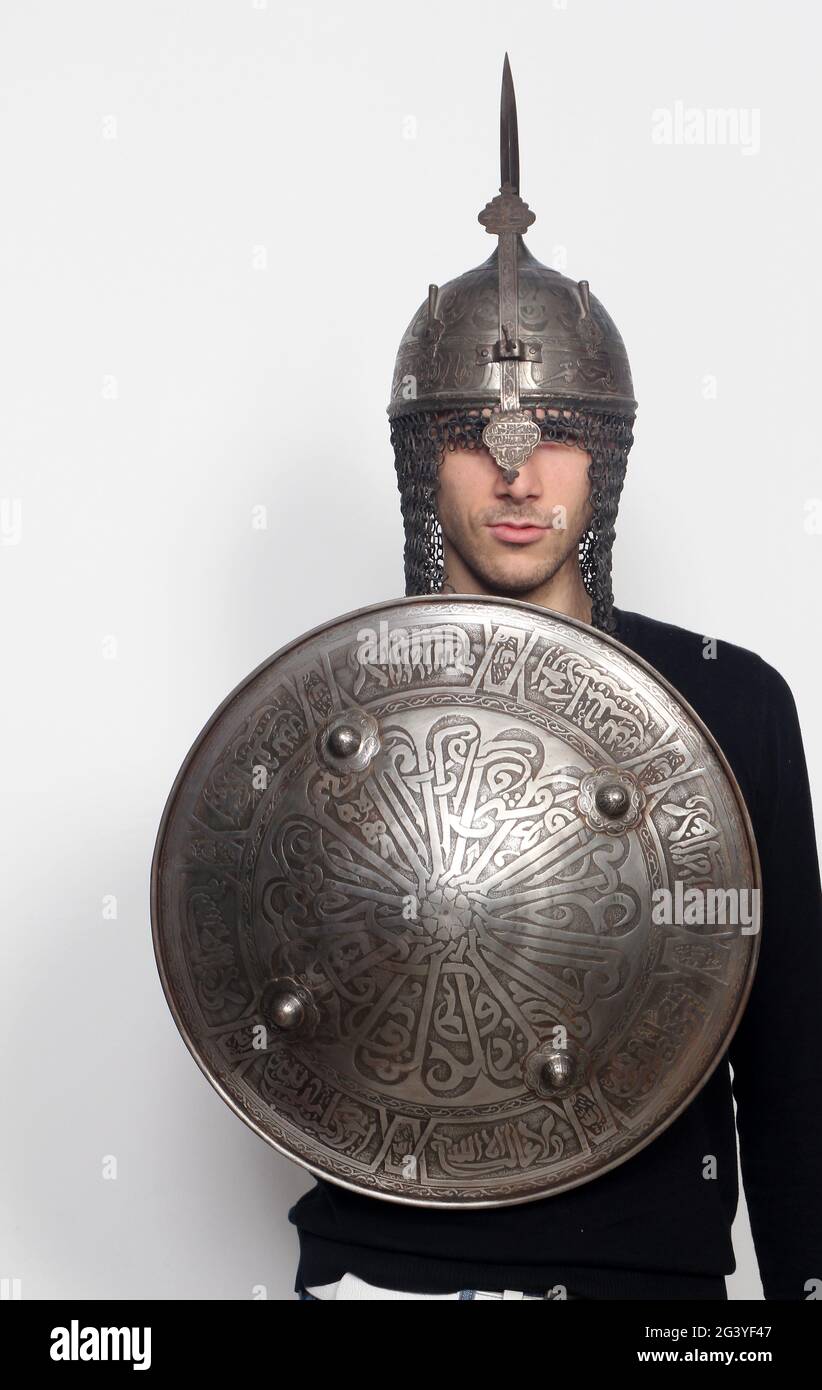 Urban warrior is posing in studio on isolated background. Costumes ...