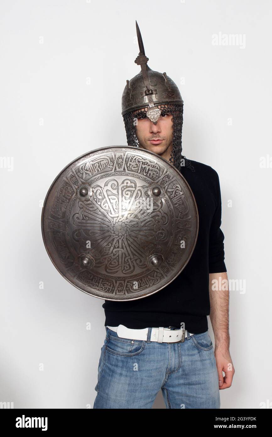 Urban warrior is posing in studio on isolated background. Costumes ...