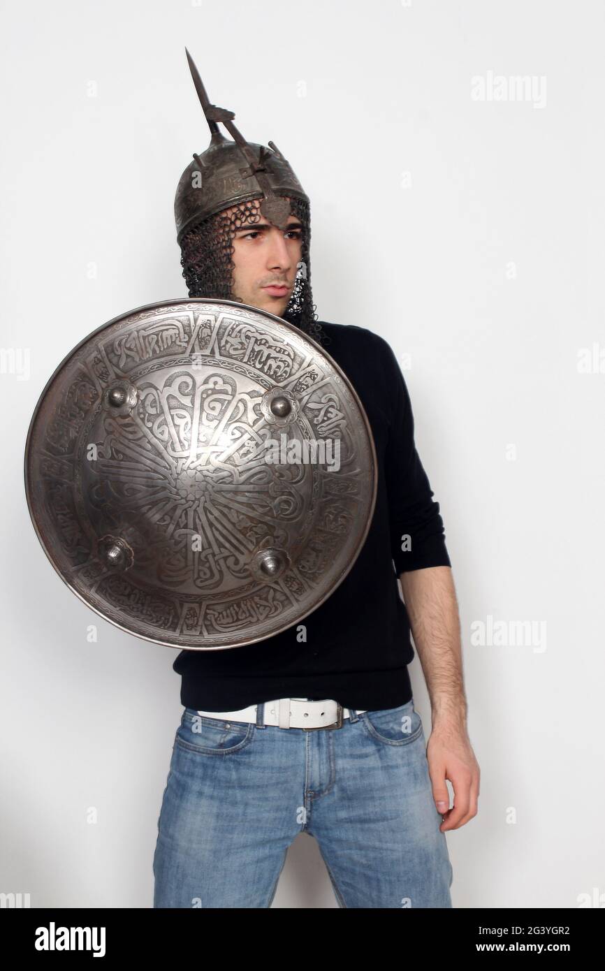 Urban warrior is posing in studio on isolated background. Costumes ...