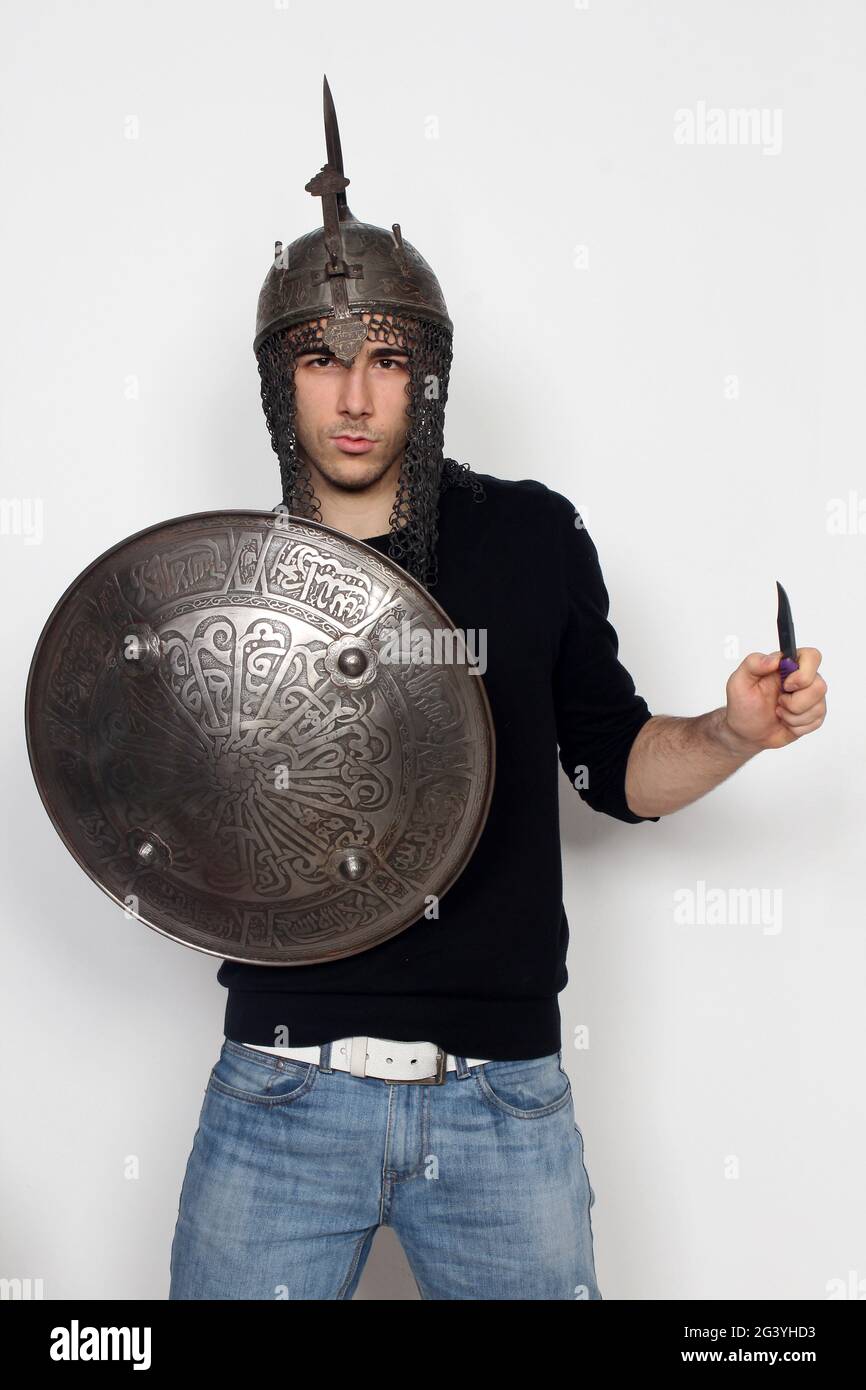 Urban warrior is posing in studio on isolated background. Costumes ...