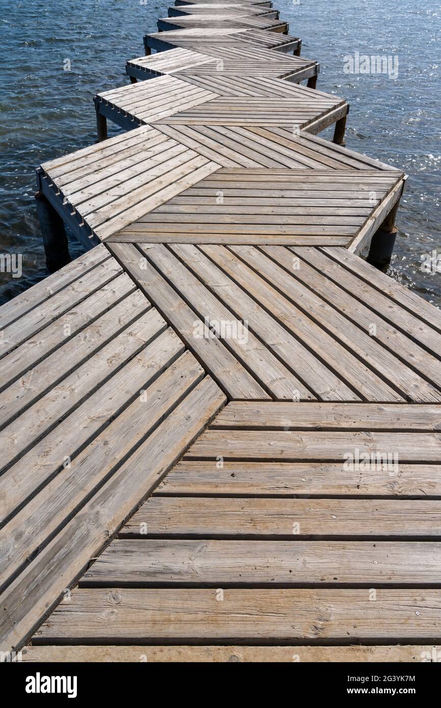 A close up low angle abstract view of a wooden boardwalk and pier ...