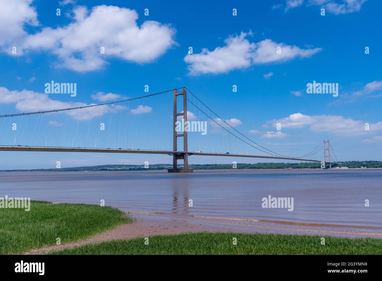 View of the Humber suspension bridge and river with blue sky on a ...